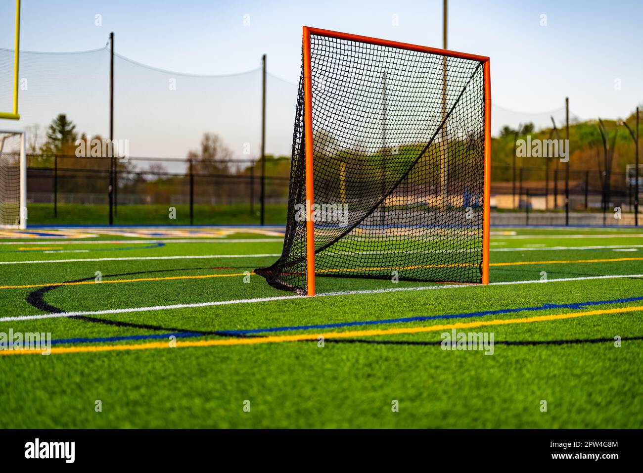 Late afternoon photo of a lacrosse goal on a synthetic turf field ...