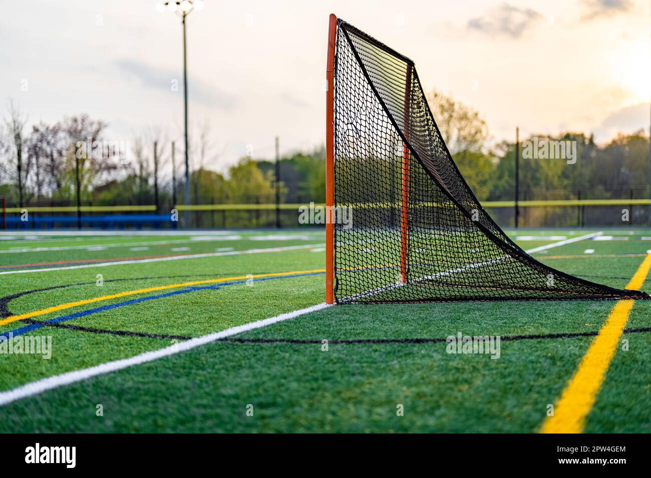 Late afternoon photo of a lacrosse goal on a synthetic turf field ...