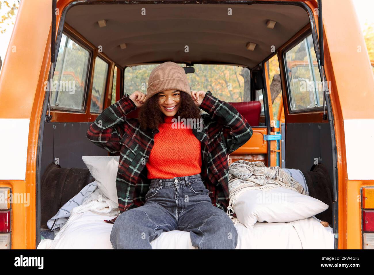 Happy joyful african american young woman traveler sitting in minivan ...