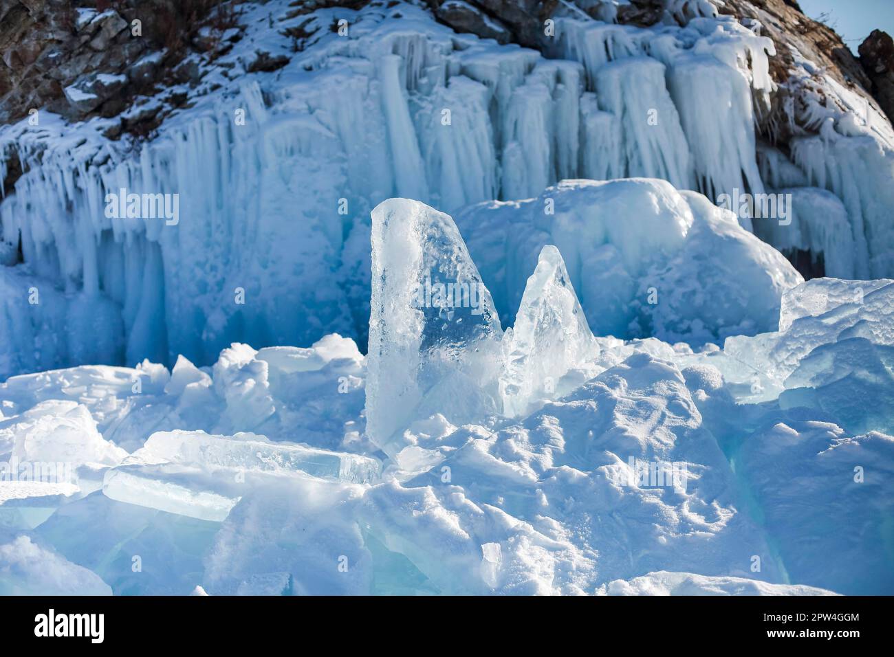 Pieces of ice lying on the ideal smooth ice of baikal with ice hummocks ...