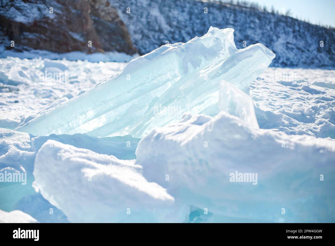 Pieces of ice lying on the ideal smooth ice of baikal with ice hummocks ...