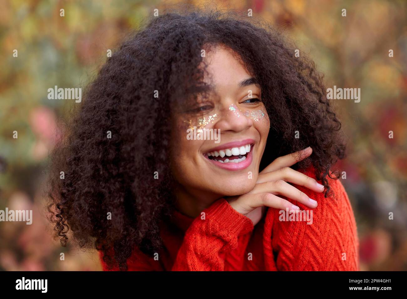 Young Happy Overjoyed African American Woman With Curly Hair Keeping