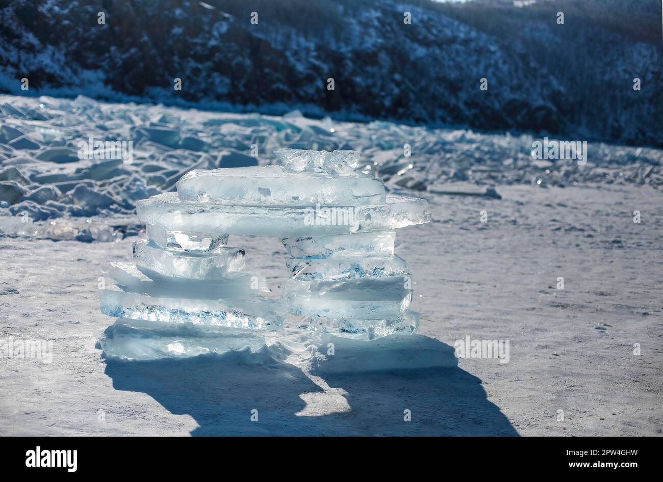 Pieces of ice lying on the ideal smooth ice of baikal with ice hummocks ...