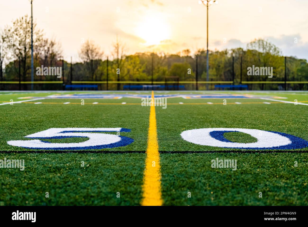 Late afternoon photo of the 50 yard line on a synthetic turf football ...