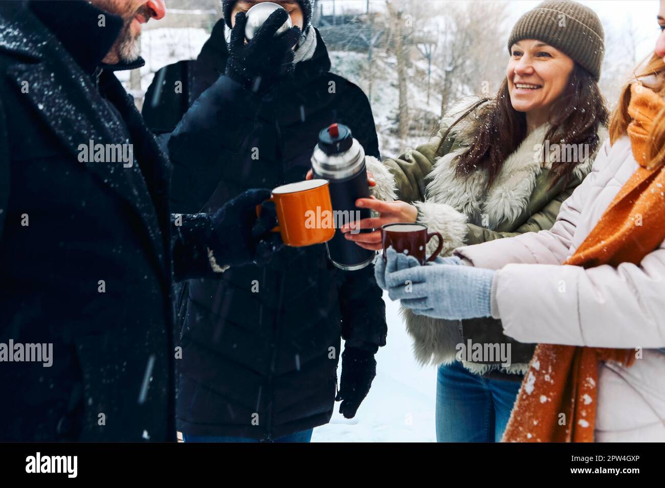 People at winter resort on winter holidays. Friends relaxing, drinking ...