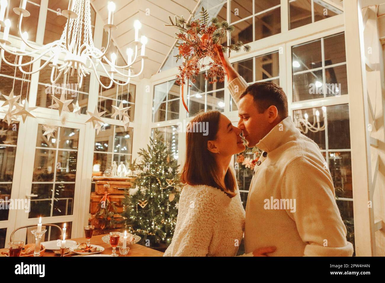 Midnight kiss. Young happy family couple in love kissing and hugging ...