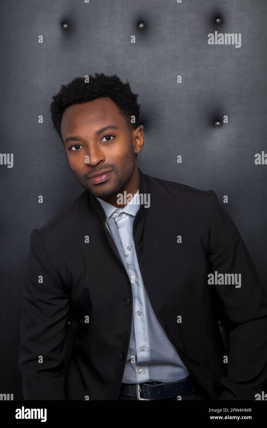 twenty year old conservative businessman suit style on black leather ...