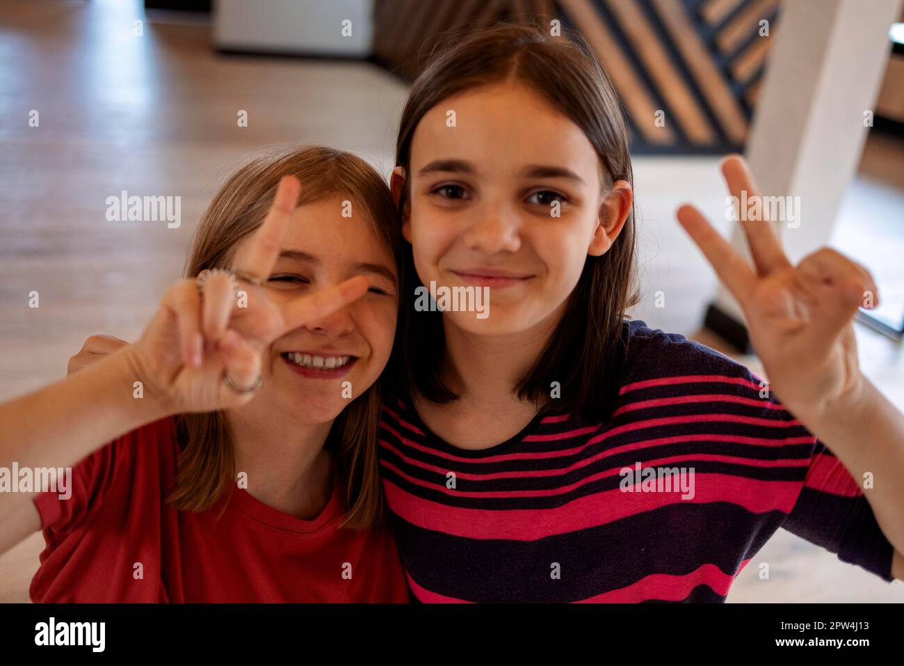 Happy young teen girls embracing indoors. Teenage female friends ...