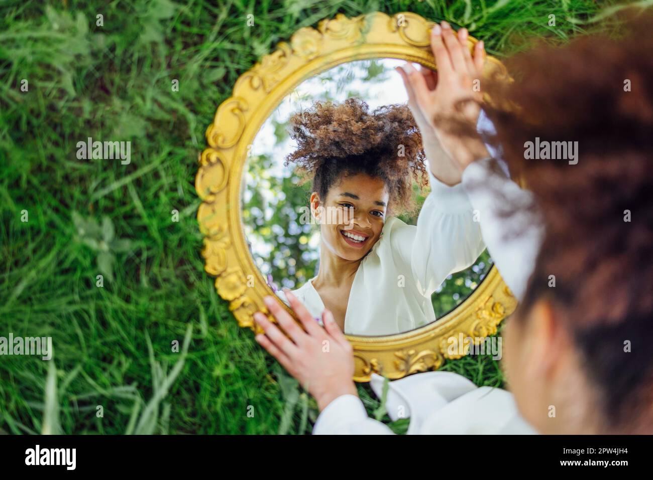 Beautifal Mixed-race woman wearing white dress and sky reflection in ...