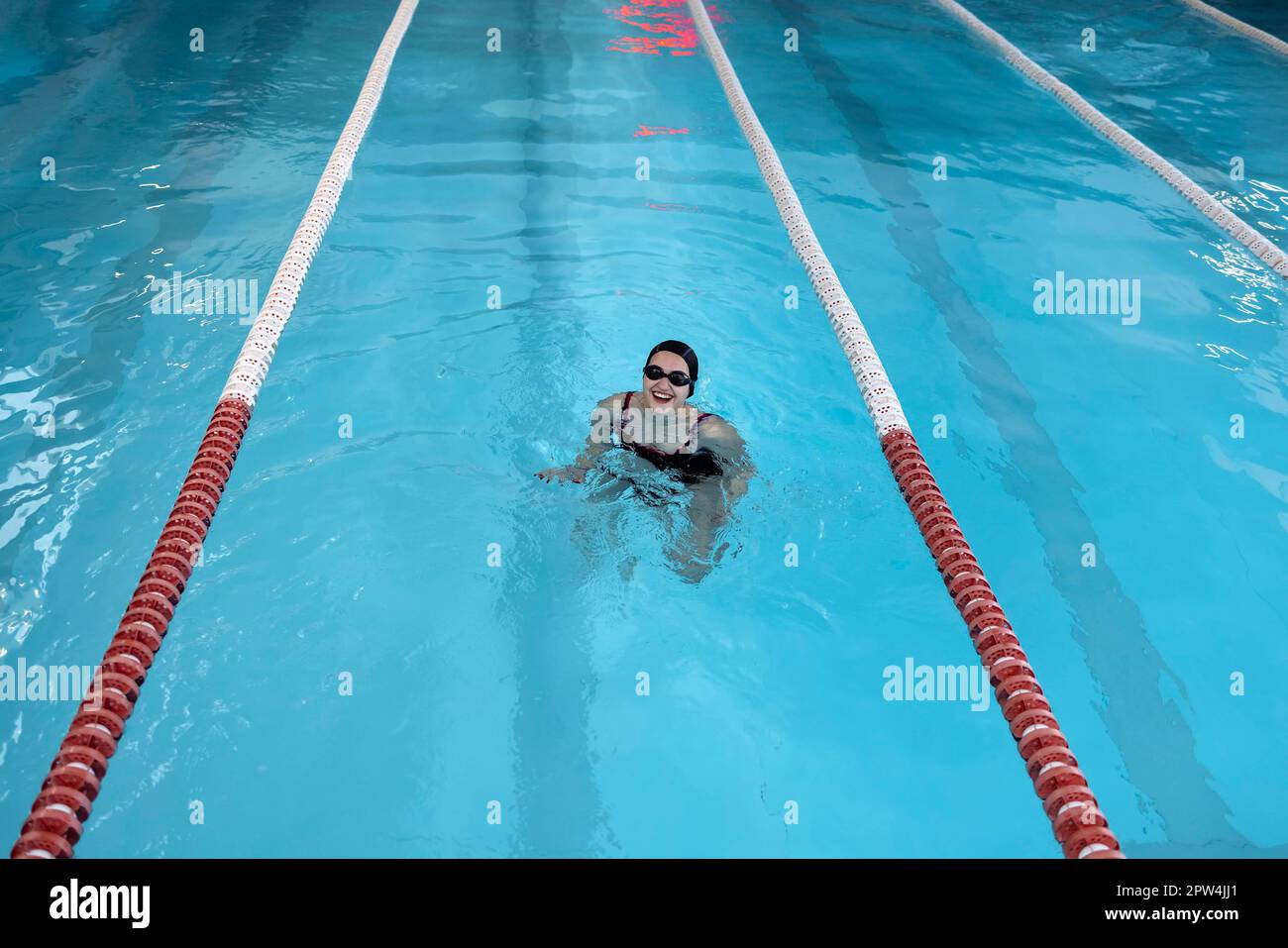 Portrait of a fit woman catcher in the pool looking to the camera ...