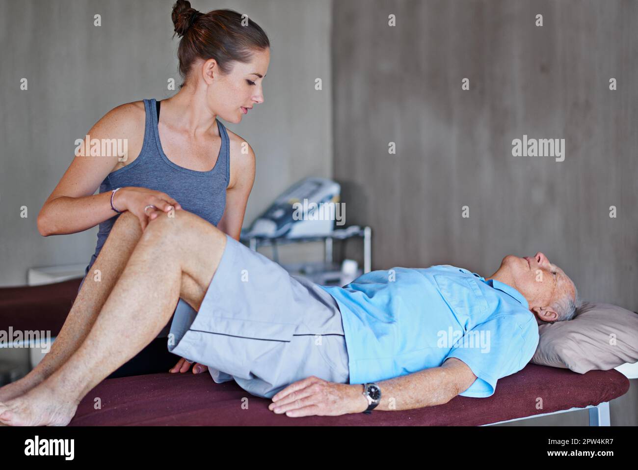 Recovery is a long process. an elderly man having a physiotherapy ...