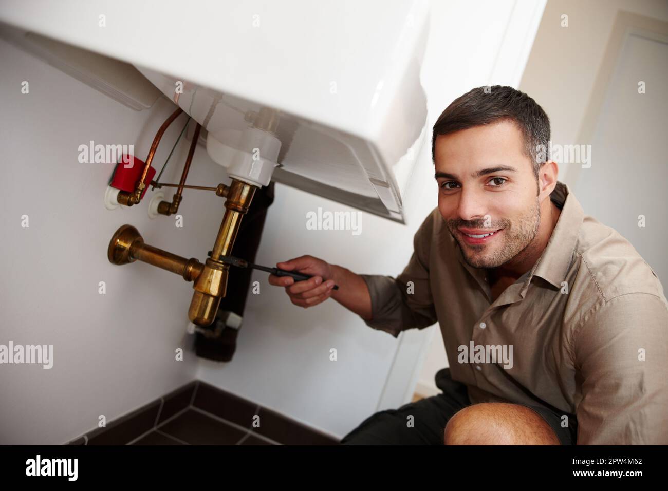 Hell work magic on your pipes. Portrait of an attractive young man ...