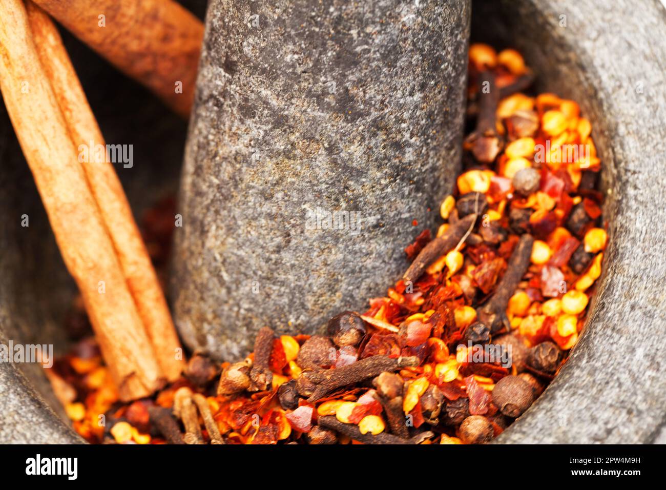 Things are going to get hot. a mortar and pestle with chilli seeds ...