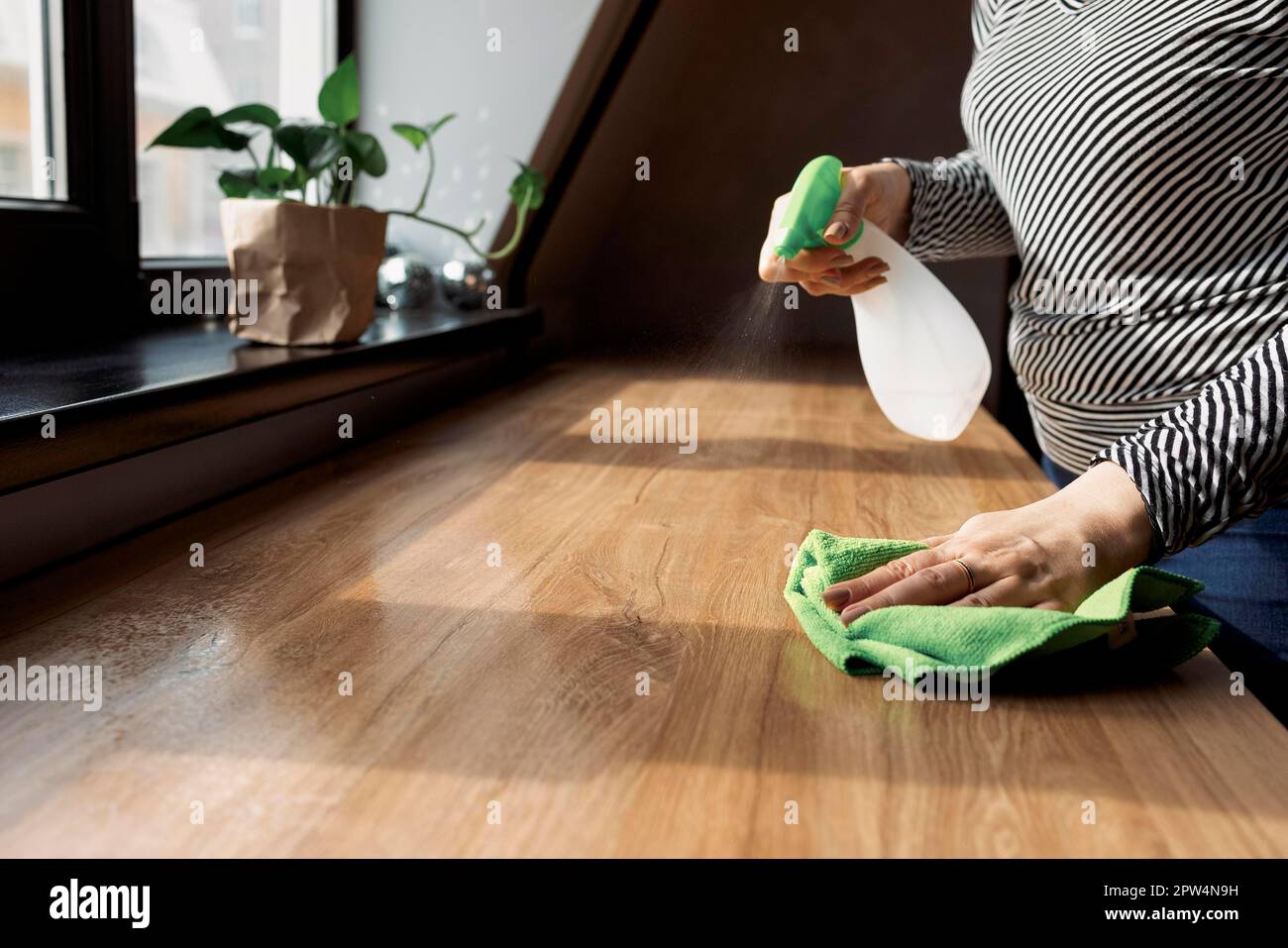 Cleaning the home table disinfecting the kitchen table surface with a ...