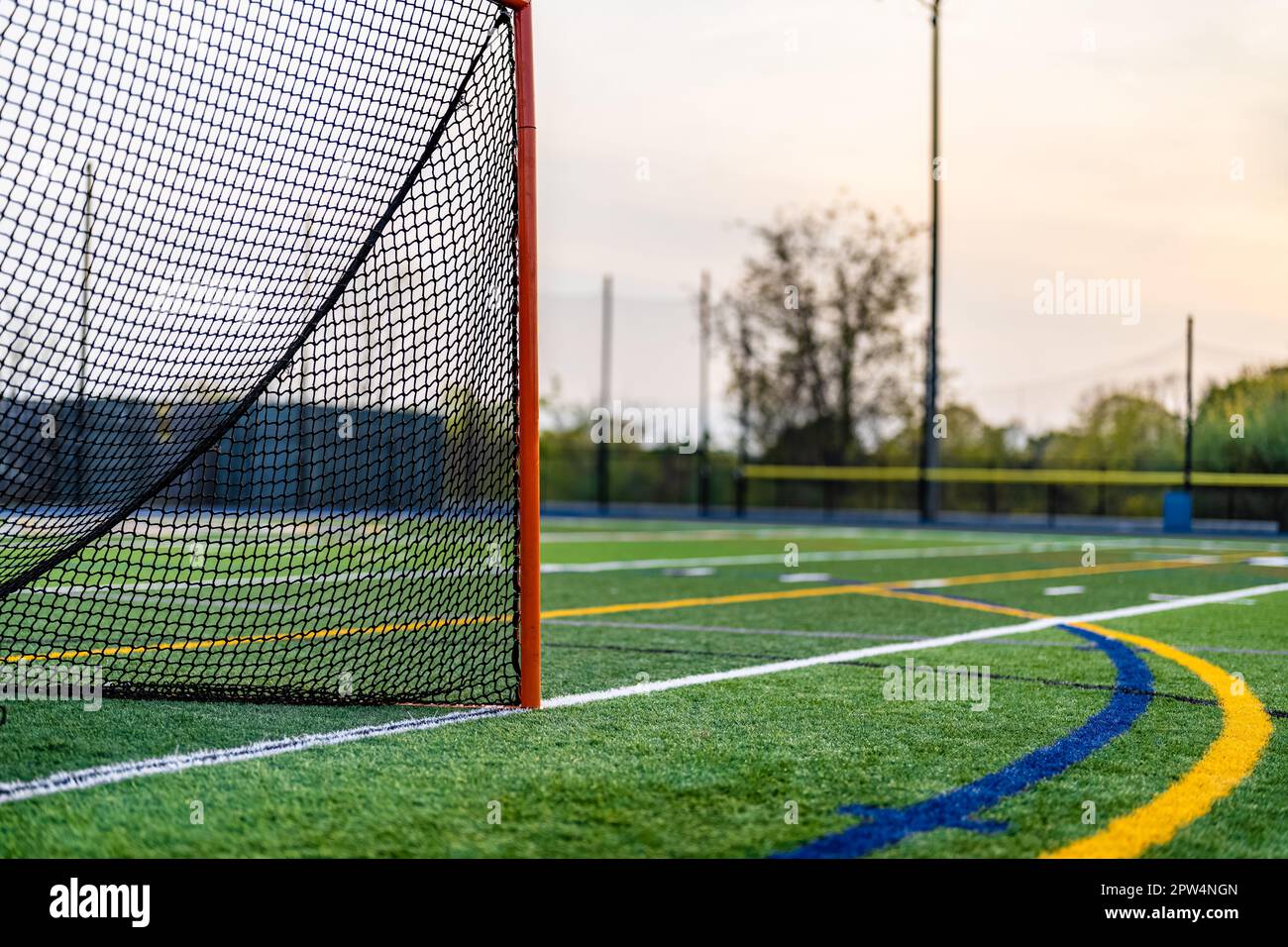 Late afternoon photo of a lacrosse goal on a synthetic turf field ...