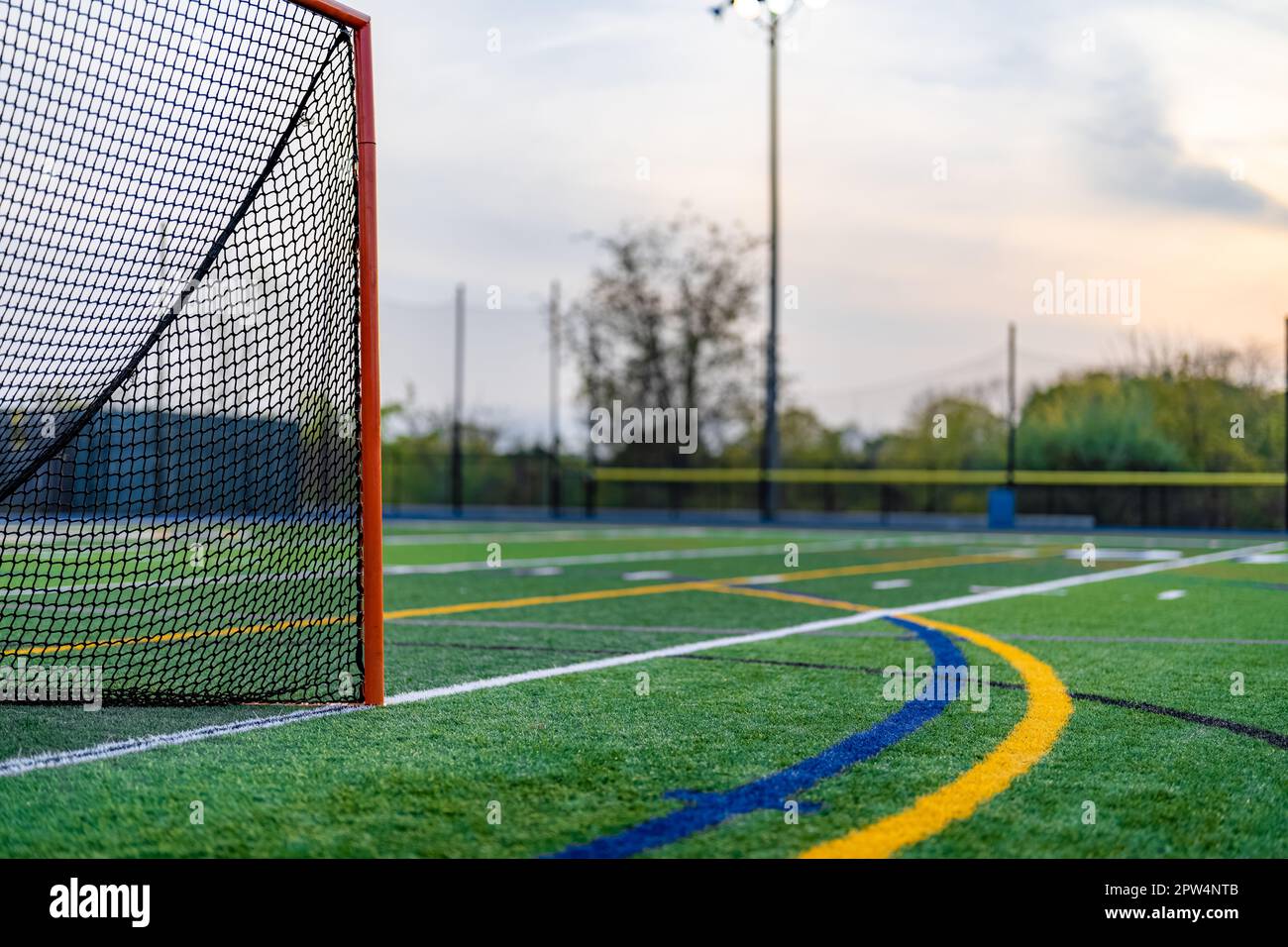 Late afternoon photo of a lacrosse goal on a synthetic turf field ...