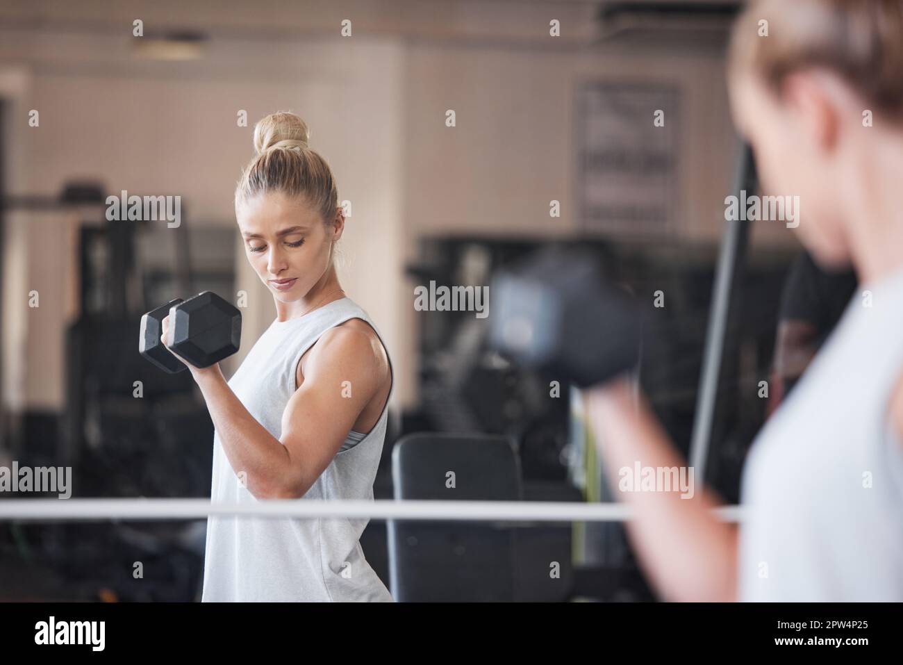 Woman, bodybuilder and gym with dumbbell, focus or fitness for health ...