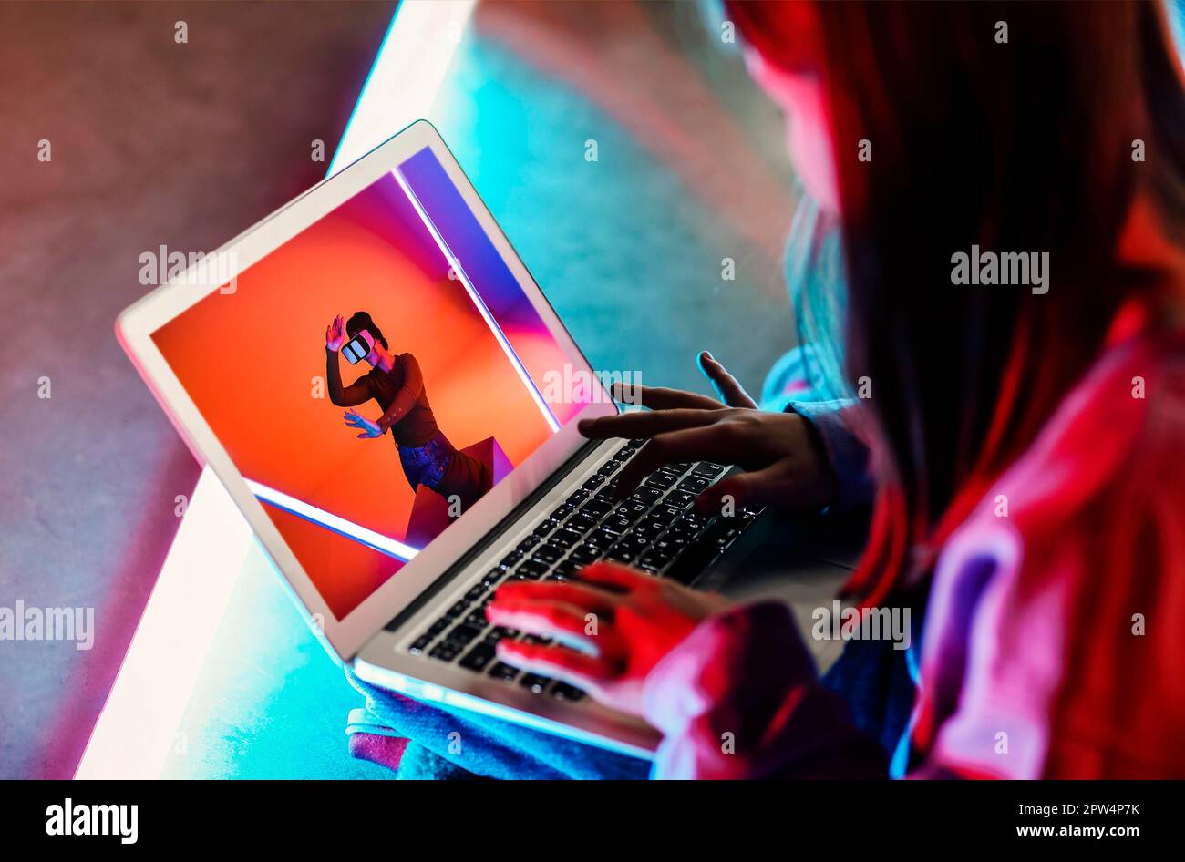 From above crop female browsing and watching video of woman in VR ...