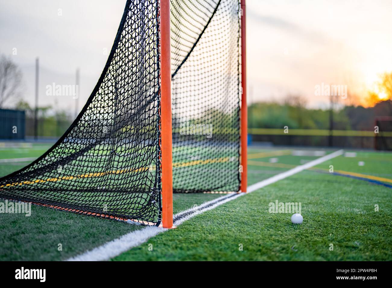 Late afternoon photo of a lacrosse goal on a synthetic turf field ...