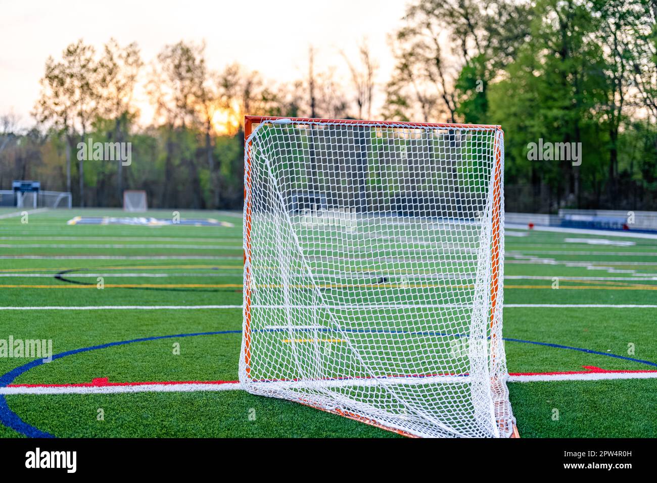 Late afternoon photo of a lacrosse goal on a synthetic turf field ...