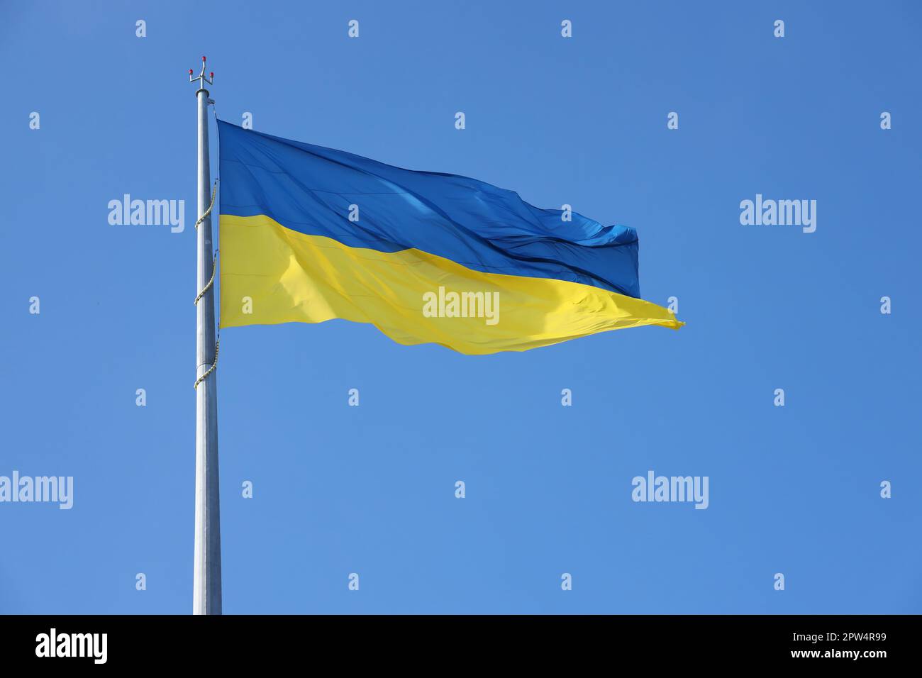 Ukrainian flag isolated on the blue sky with clipping path. Close up ...