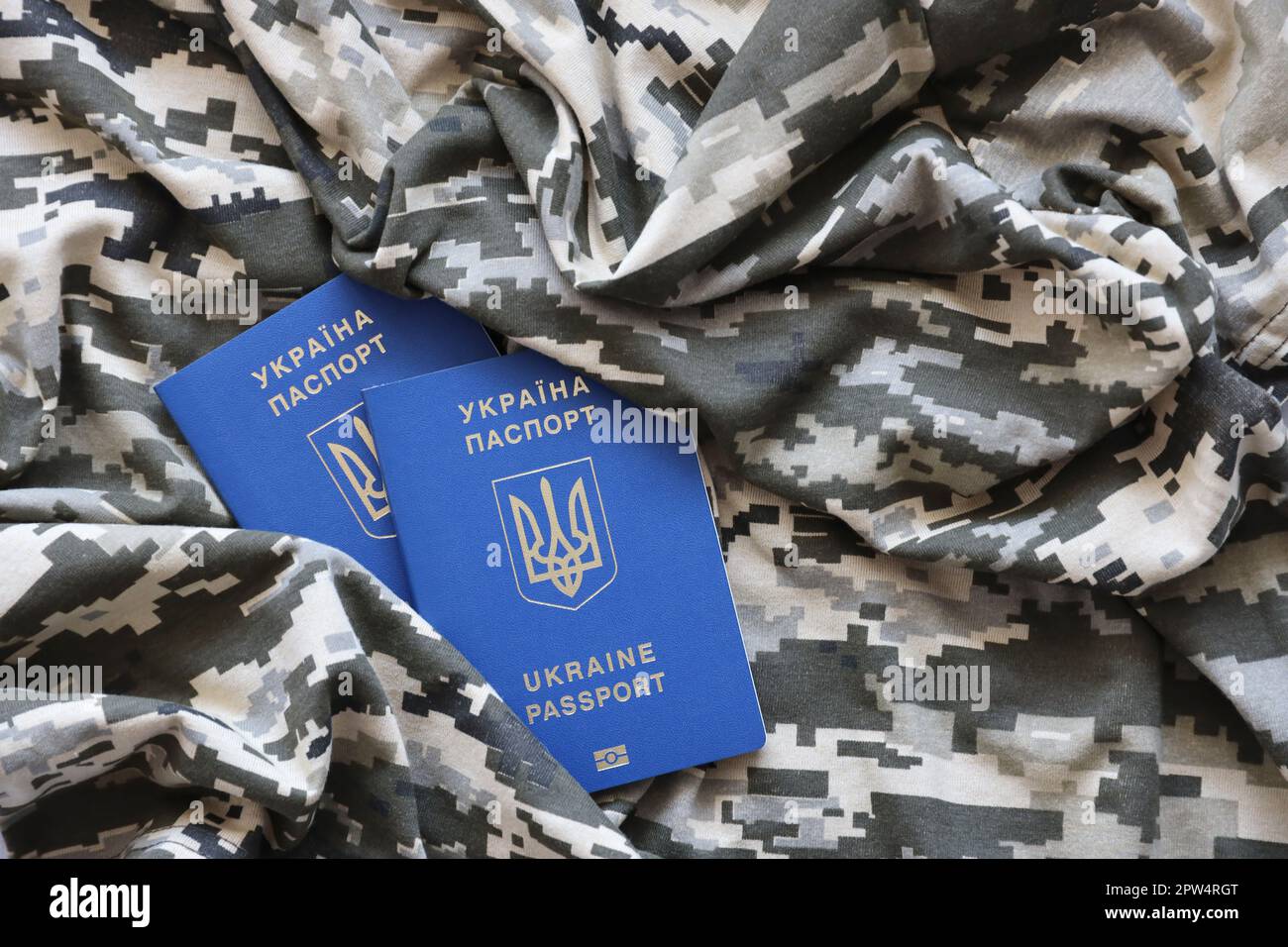 Ukrainian foreign passport on fabric with texture of military pixeled ...