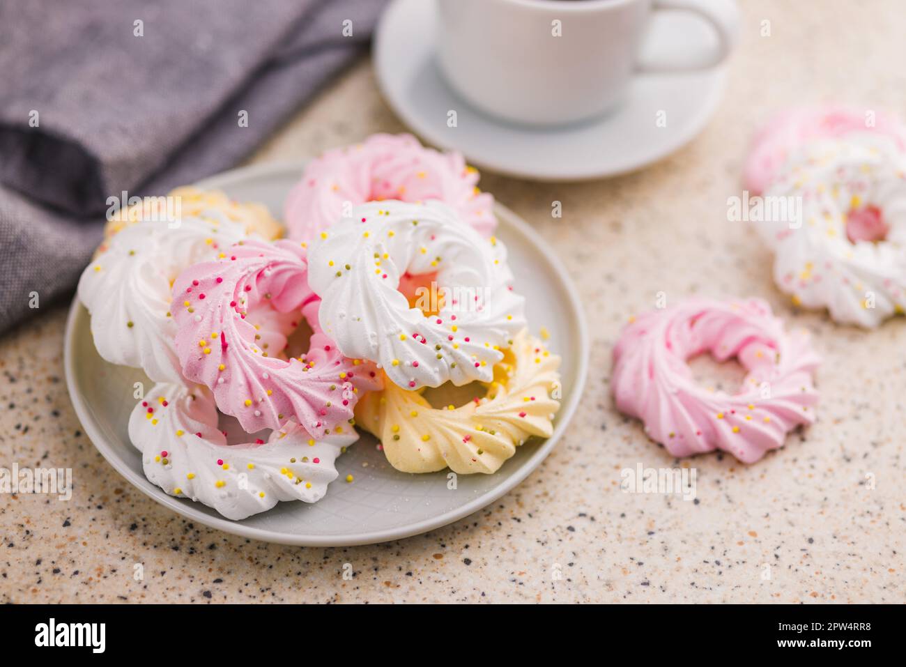 Different colors meringues with sprinkles on the plate Stock Photo - Alamy