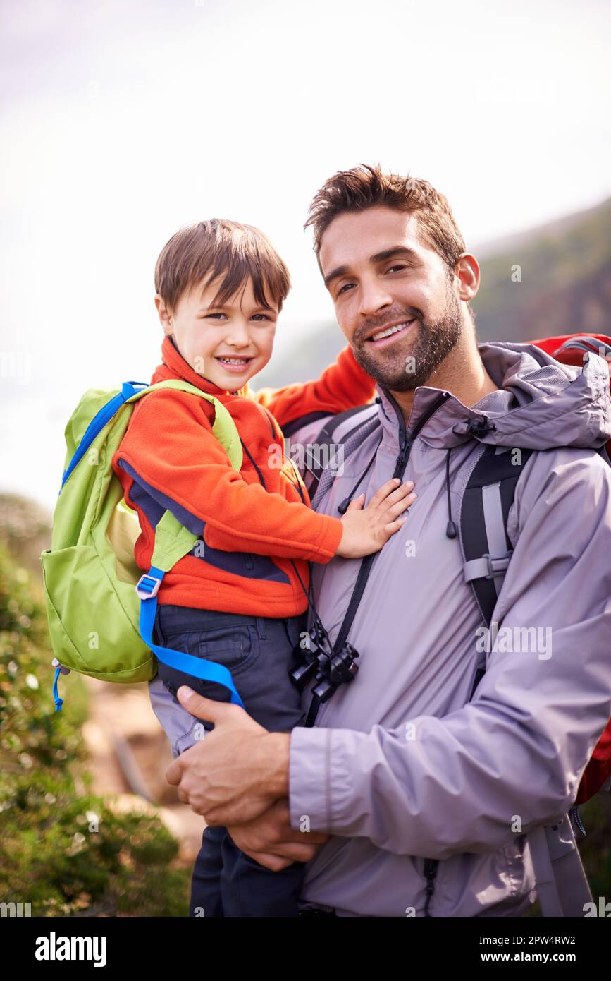 Doing what boys do best. Portrait of a father and son enjoying a hike ...