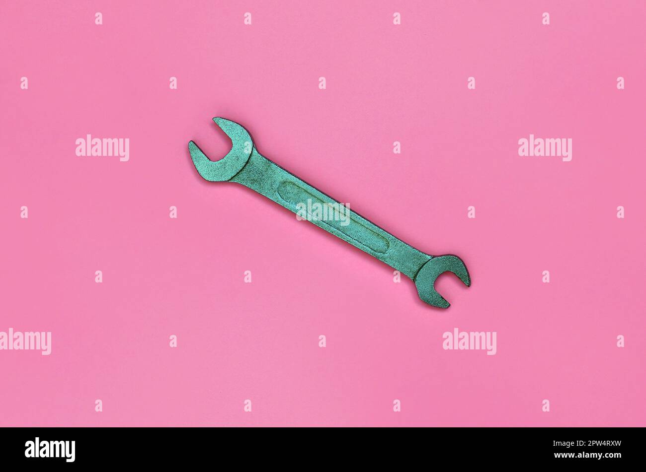 Metallic spanner lie on texture background of fashion pastel pink color ...