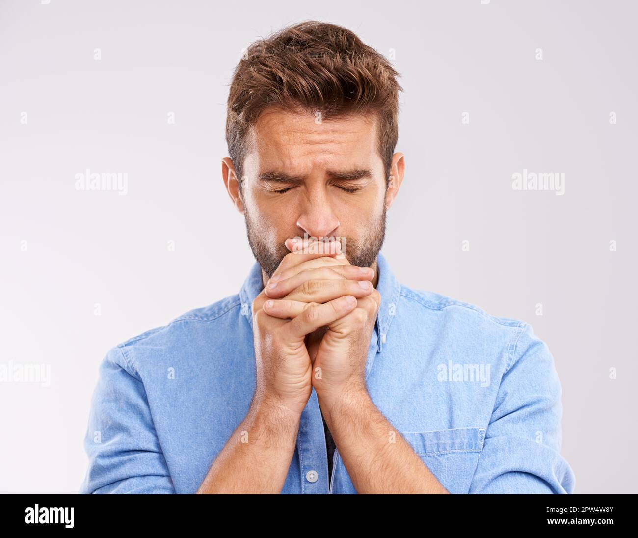 Sometimes prayer is the only thing you can do. Studio shot of a ...