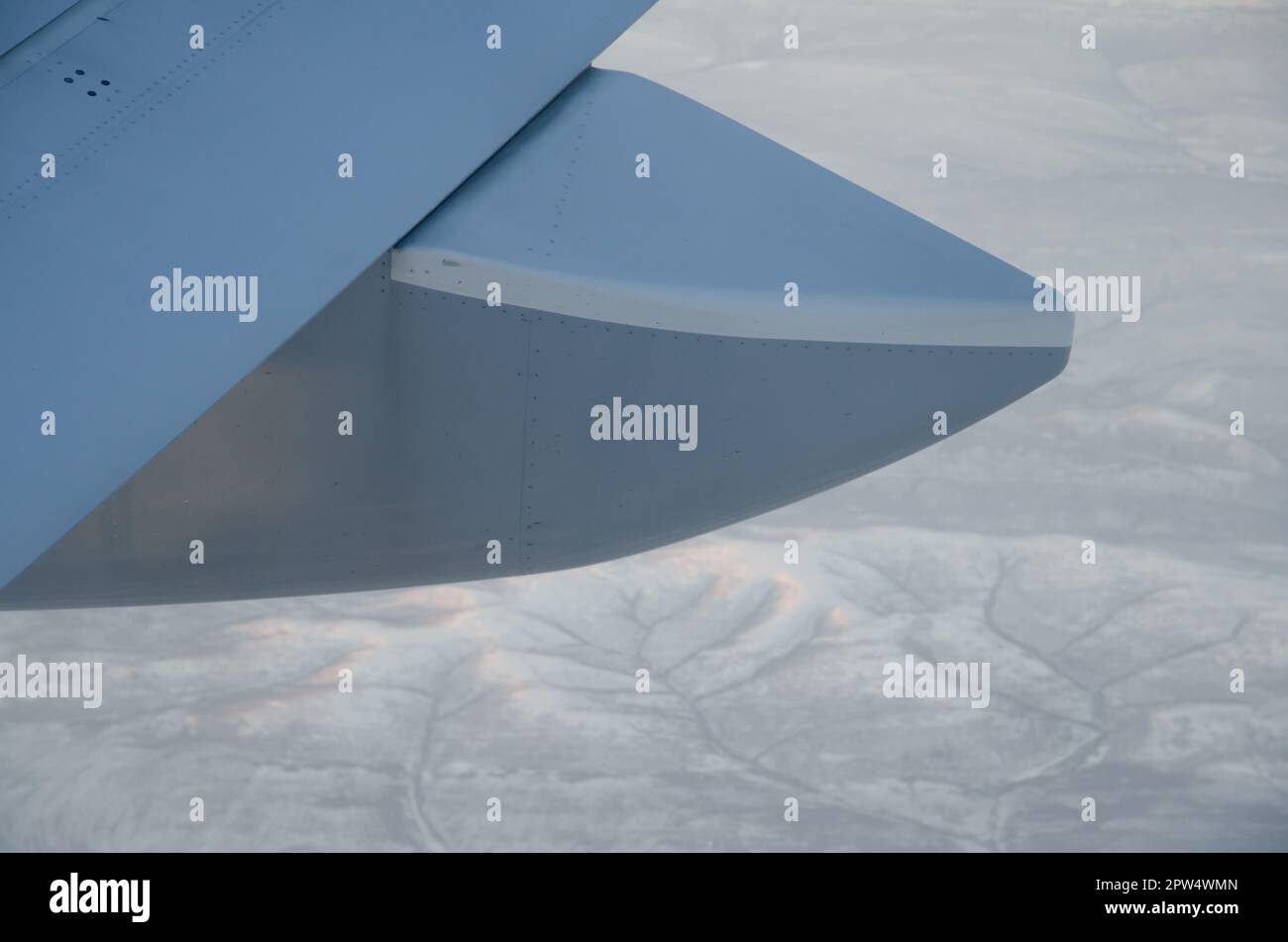 Detail of the wing of an aircraft flying over Siberia. Russia Stock ...