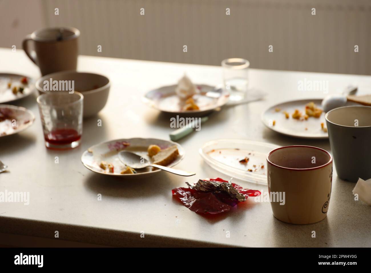 Empty dirty plates with spoons and forks on the table after meal ...