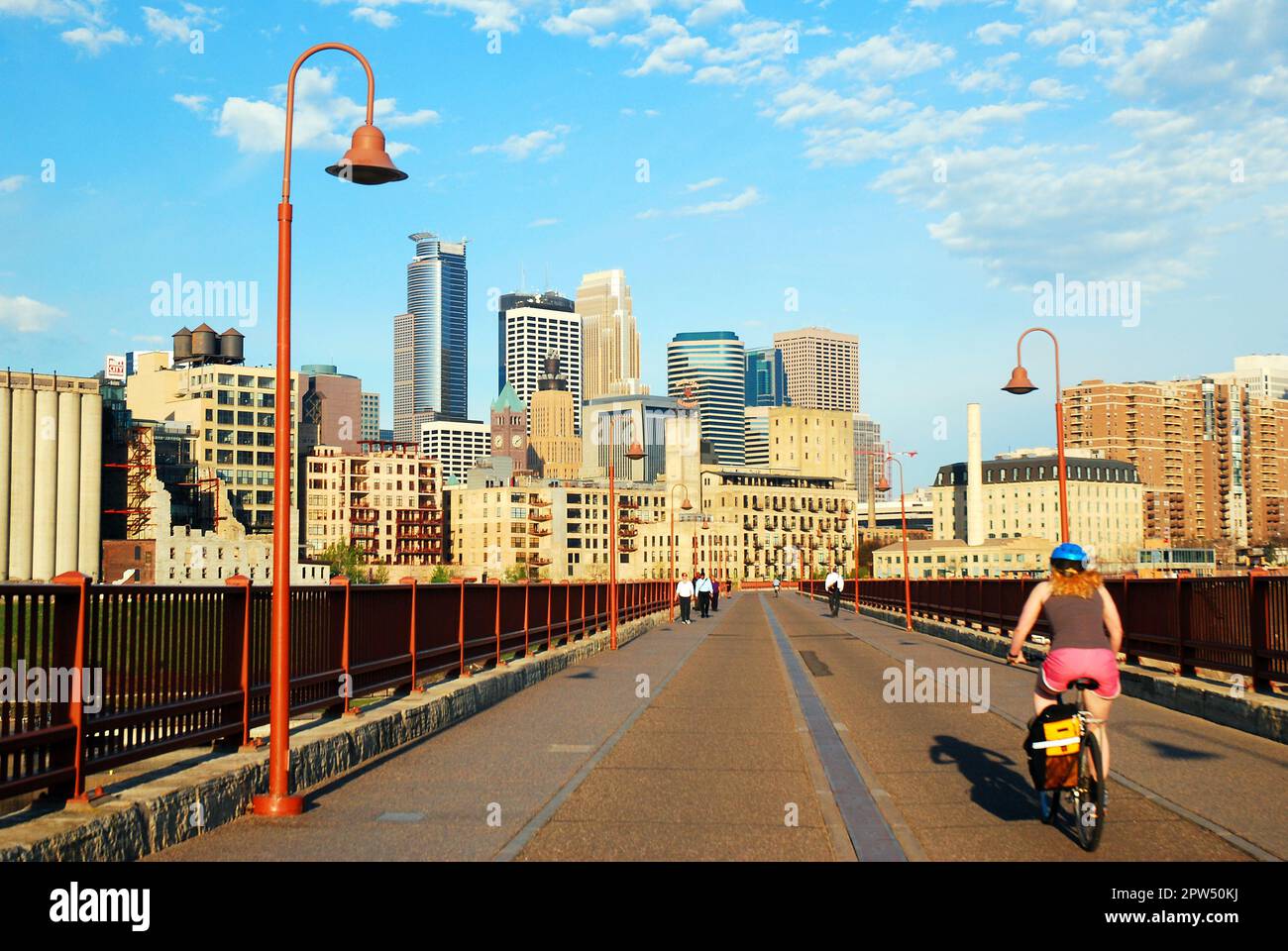 Woman rides bike over bridge hi-res stock photography and images - Alamy
