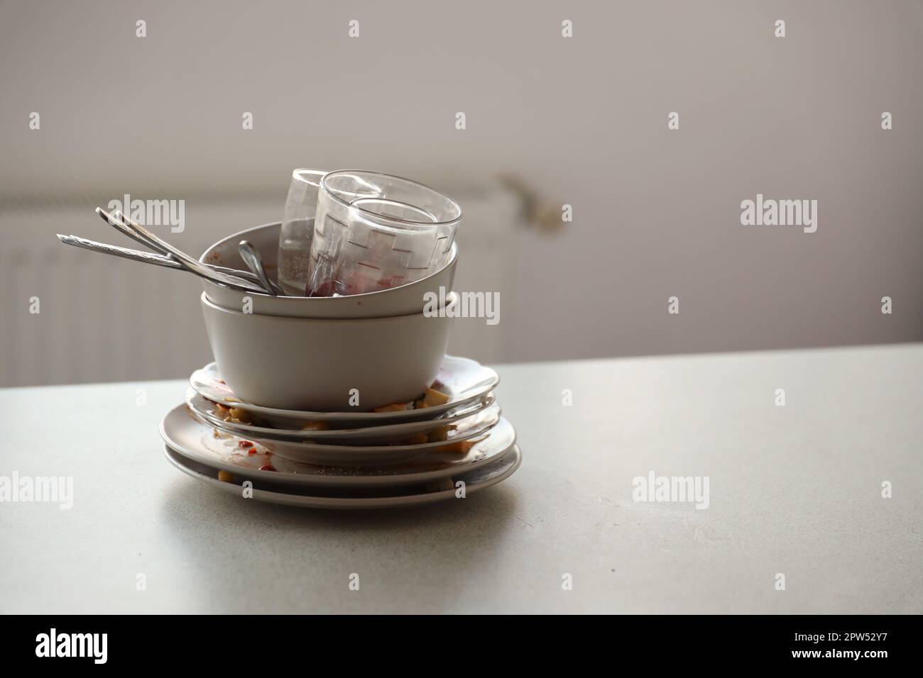 Stack of dirty dishes with food leftovers on the table after meal ...