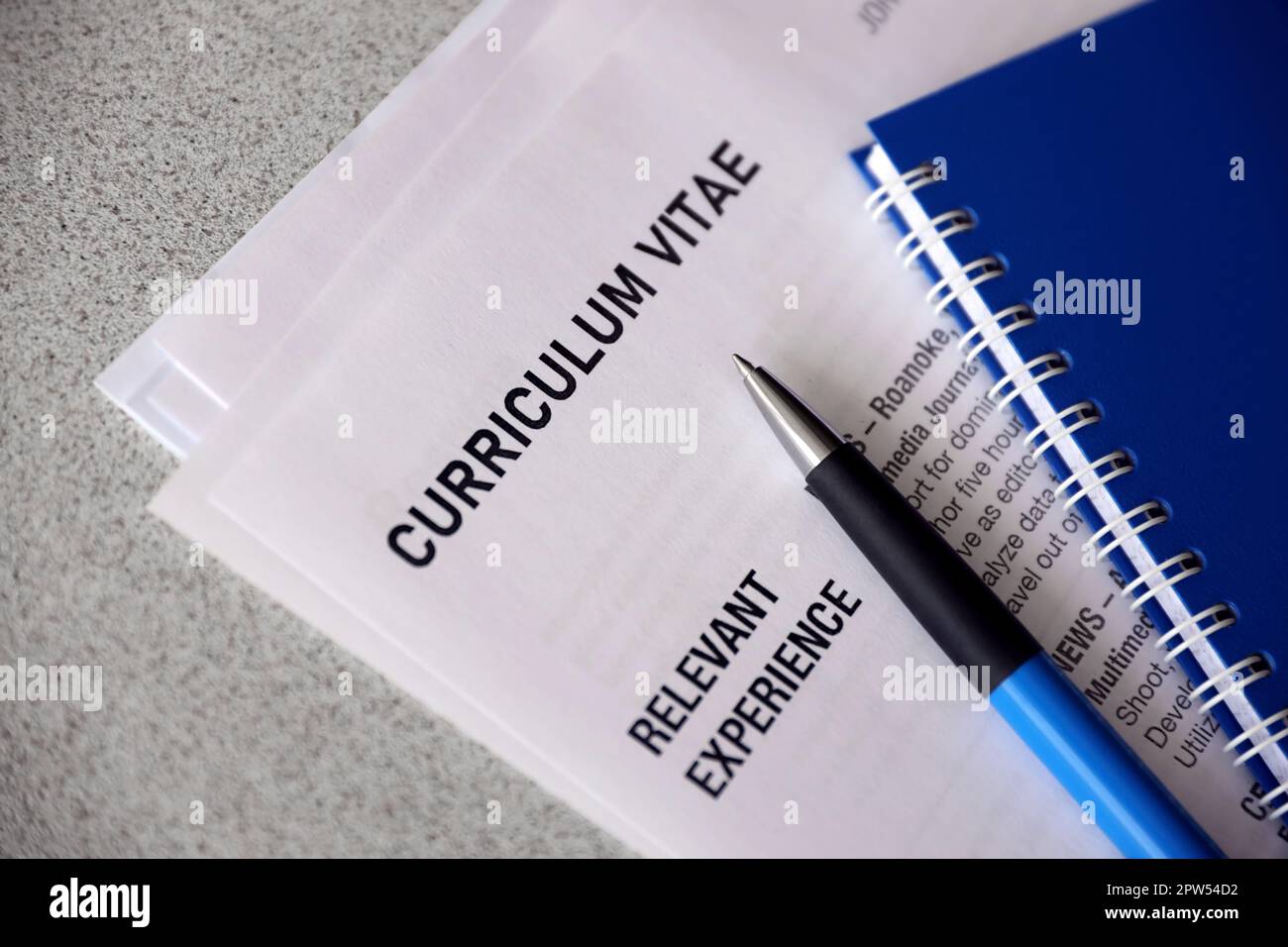 Top view of stack of office documents including resume and cv forms on ...