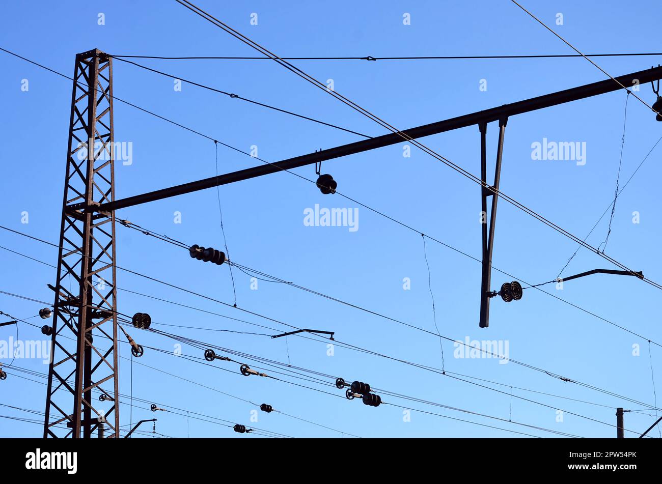 Railroad overhead lines against clear blue sky, Contact wire. High ...
