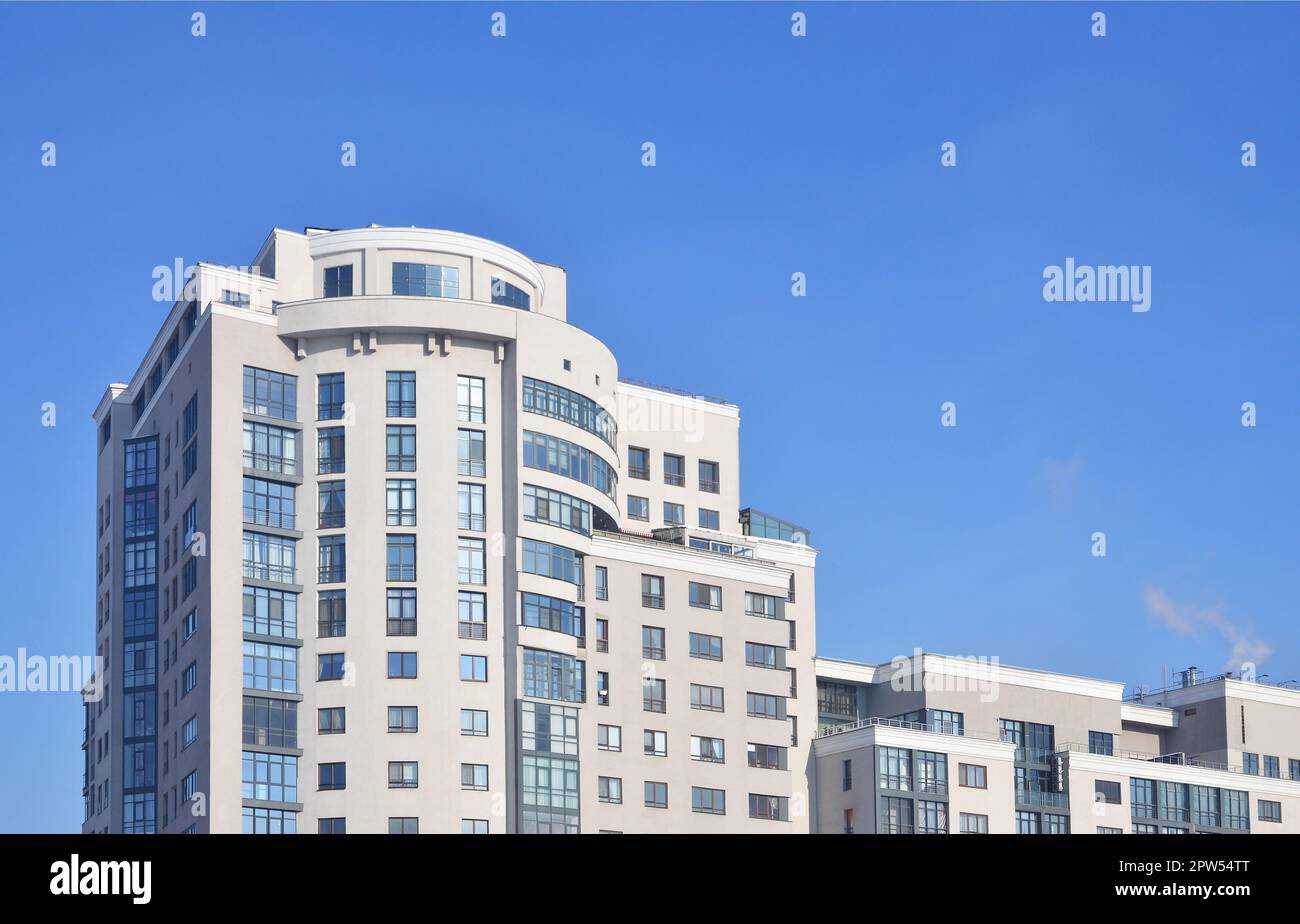Multi-story office building beige color with lots of glass windows on a ...