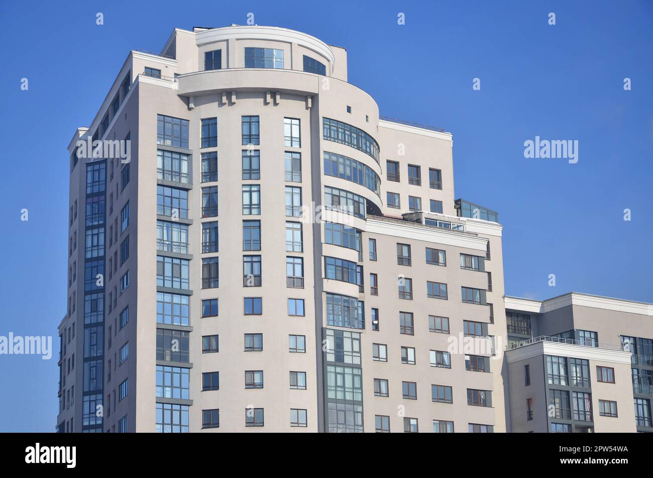 Multi-story office building beige color with lots of glass windows on a ...