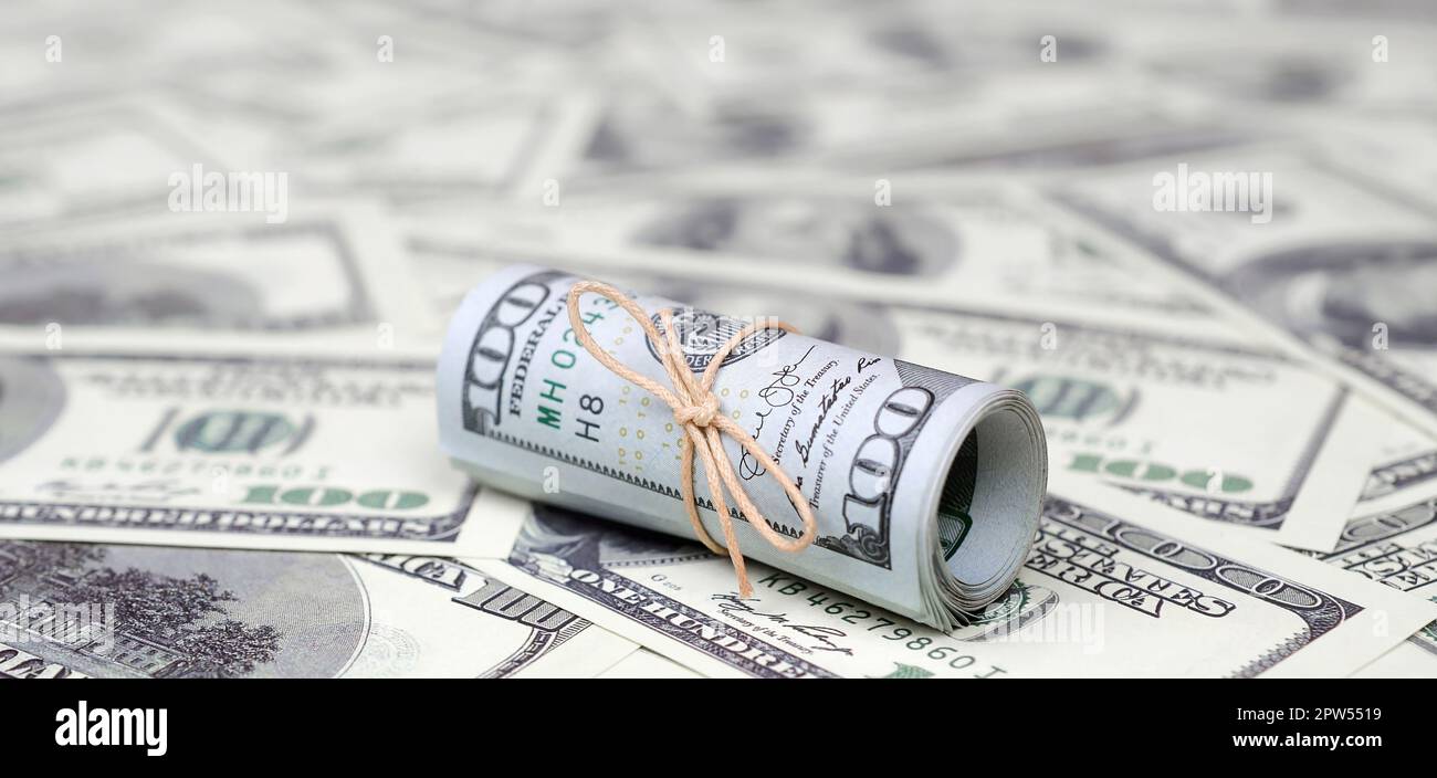US dollars rolled up and tightened with band lies on a lot of american ...
