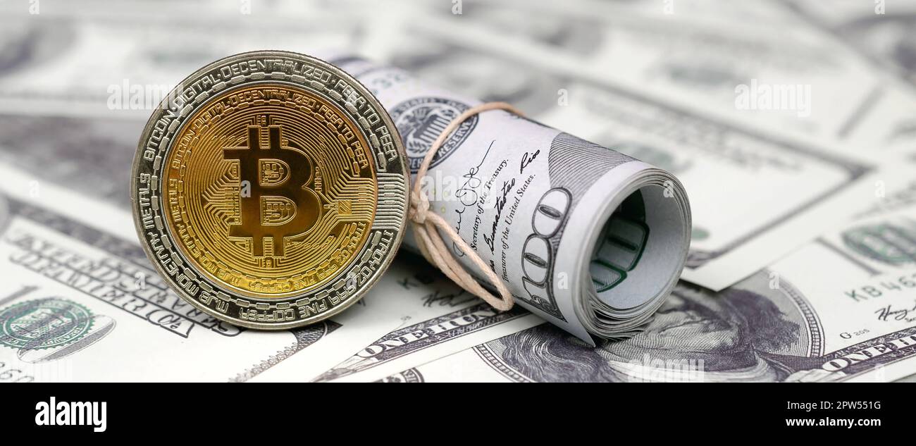 Bitcoin coin and banknotes of one hundred dollar. Conceptual image for ...