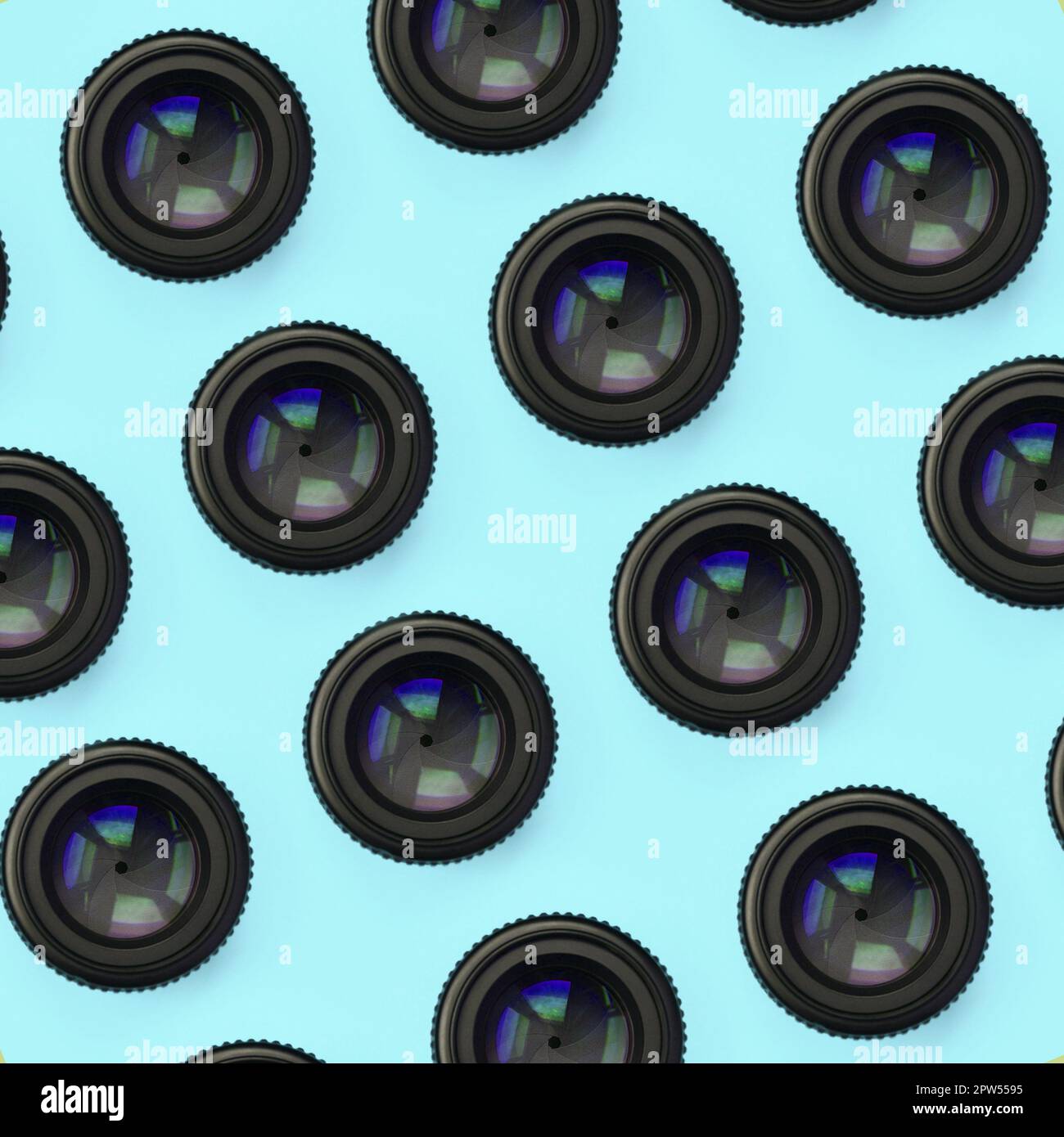 A few camera lenses with a closed aperture lie on texture background of ...