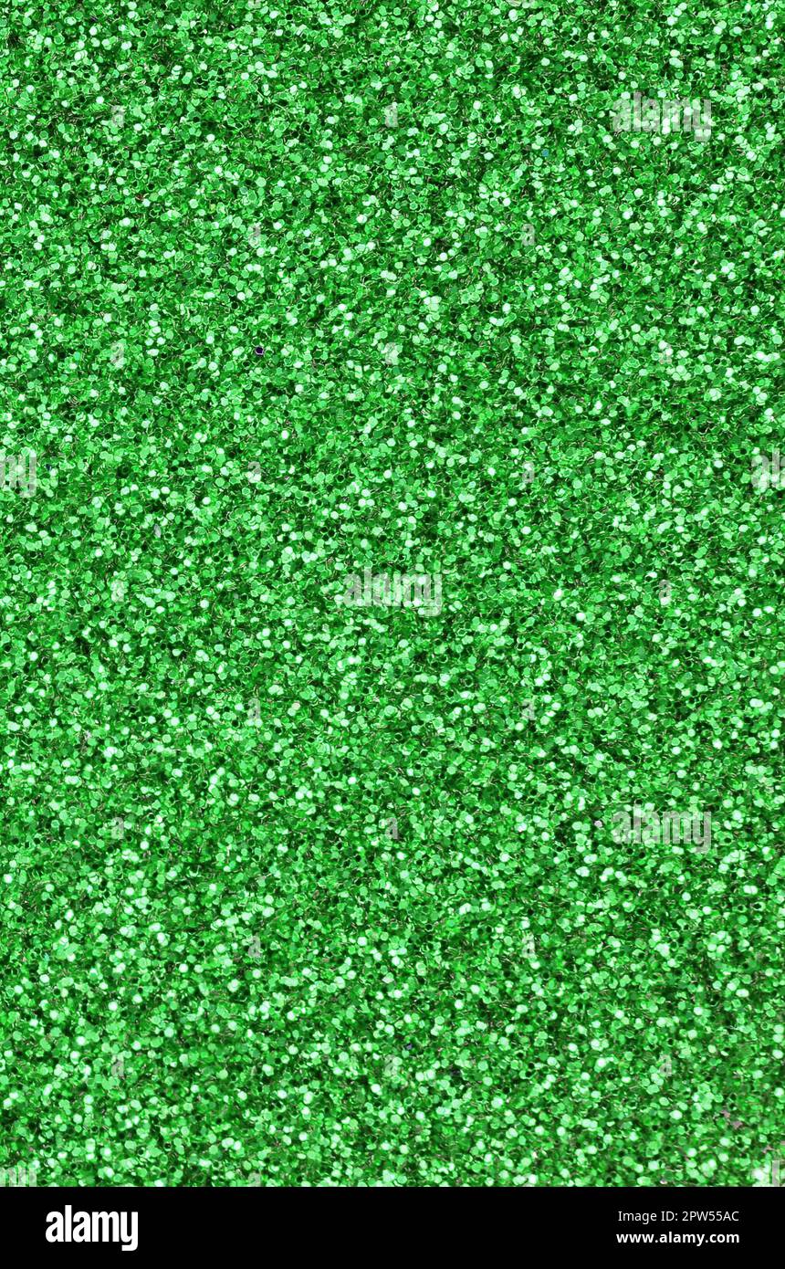 A huge amount of green decorative sequins. Background image with shiny ...
