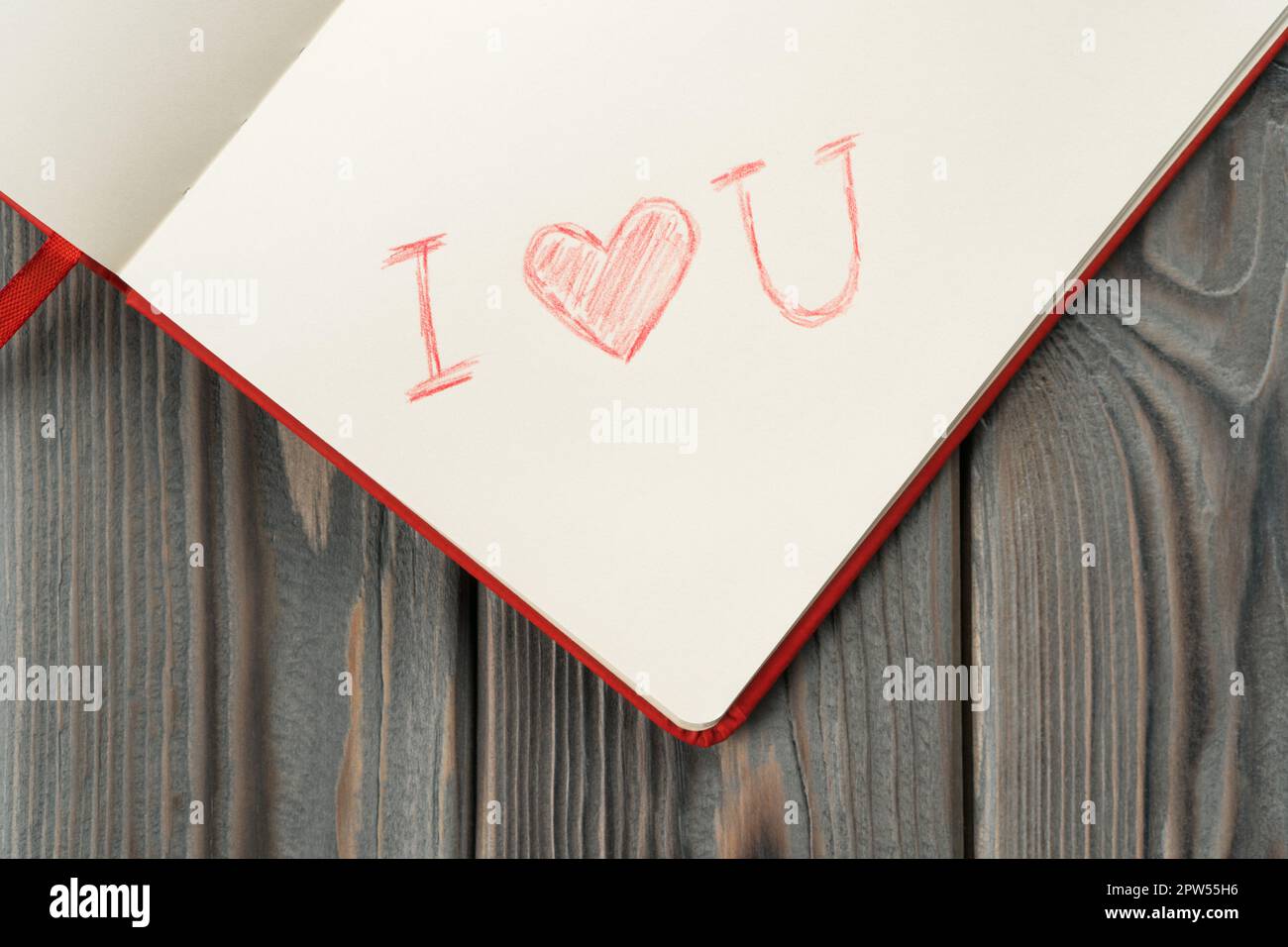 Red diary book with white paper with sign label I love you in the ...