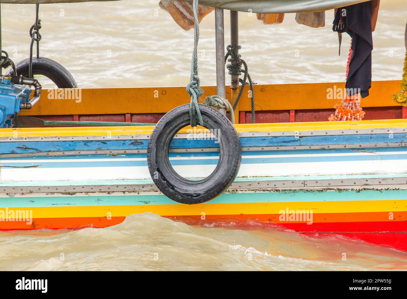 Tires tied to the side of the boat To use cushioning Stock Photo - Alamy