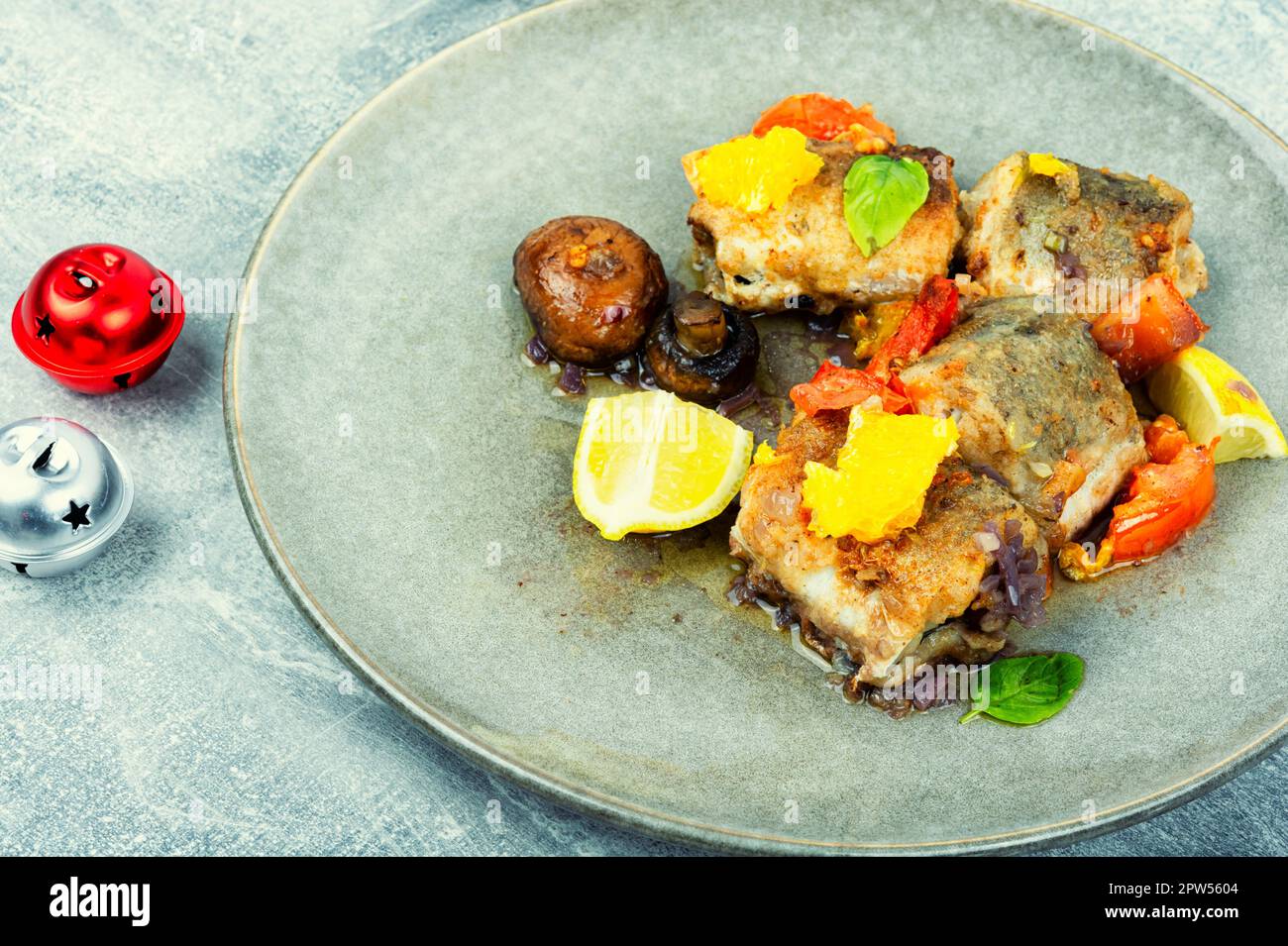 Fried hake fish with orange, tomato and mushrooms Stock Photo - Alamy
