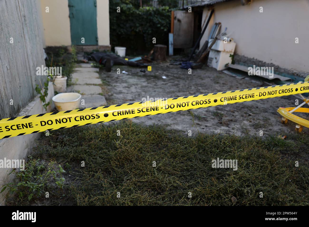 Victim of a violent crime in a backyard of residental house in evening ...