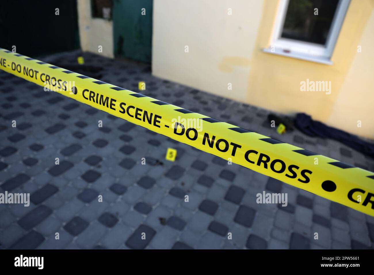 Crime scene tape for covering the area cordon. Yellow tape with blurred ...