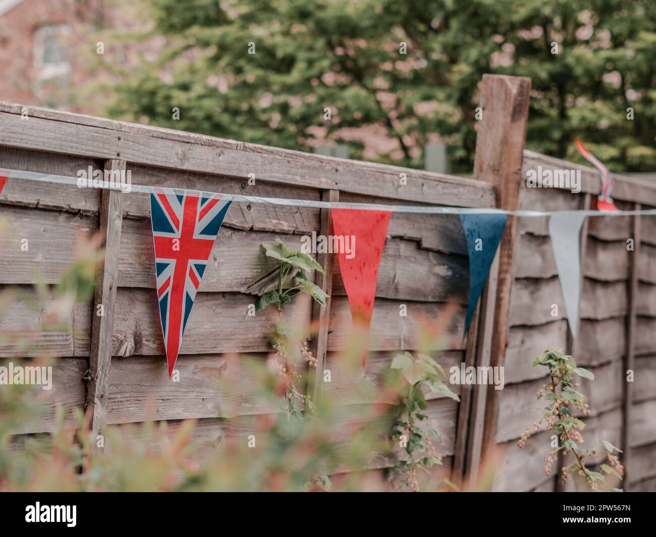 Flags of Great Britain waving on the wind in the garden of English ...