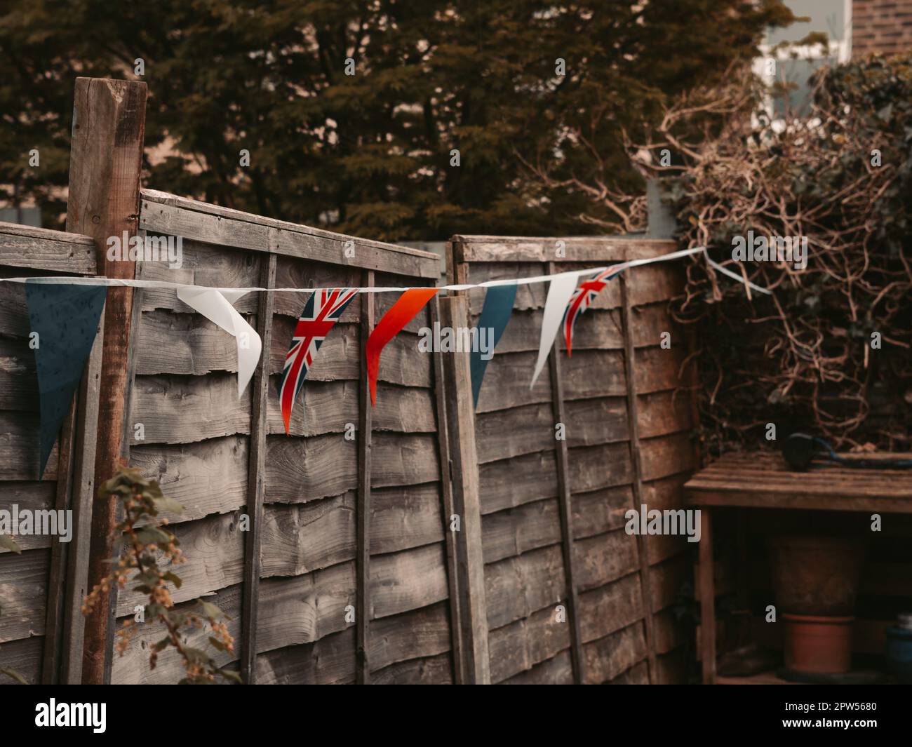 Flags of Great Britain waving on the wind in the garden of English ...
