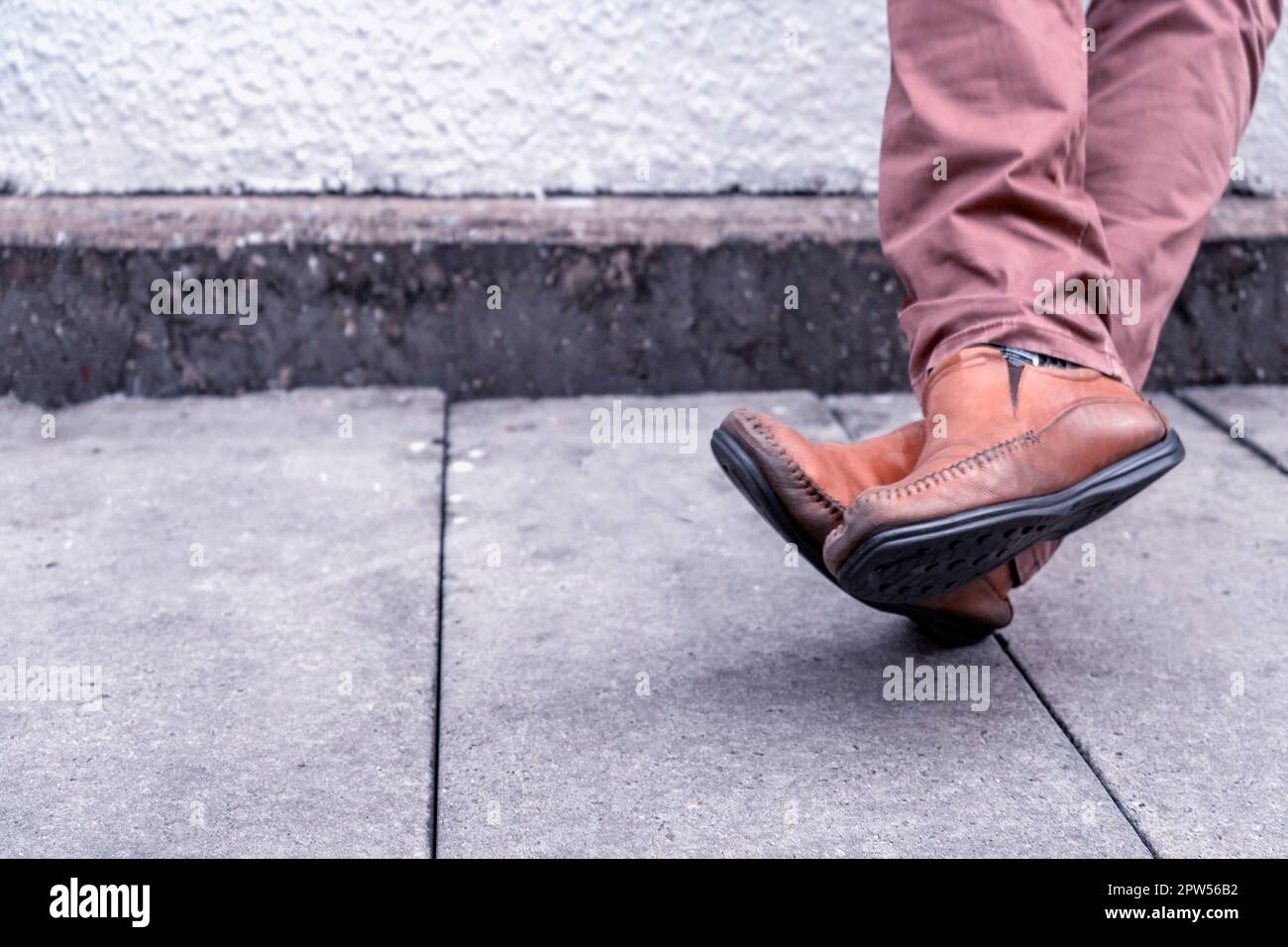 Standing leg with brown leather feet classic Stock Photo - Alamy